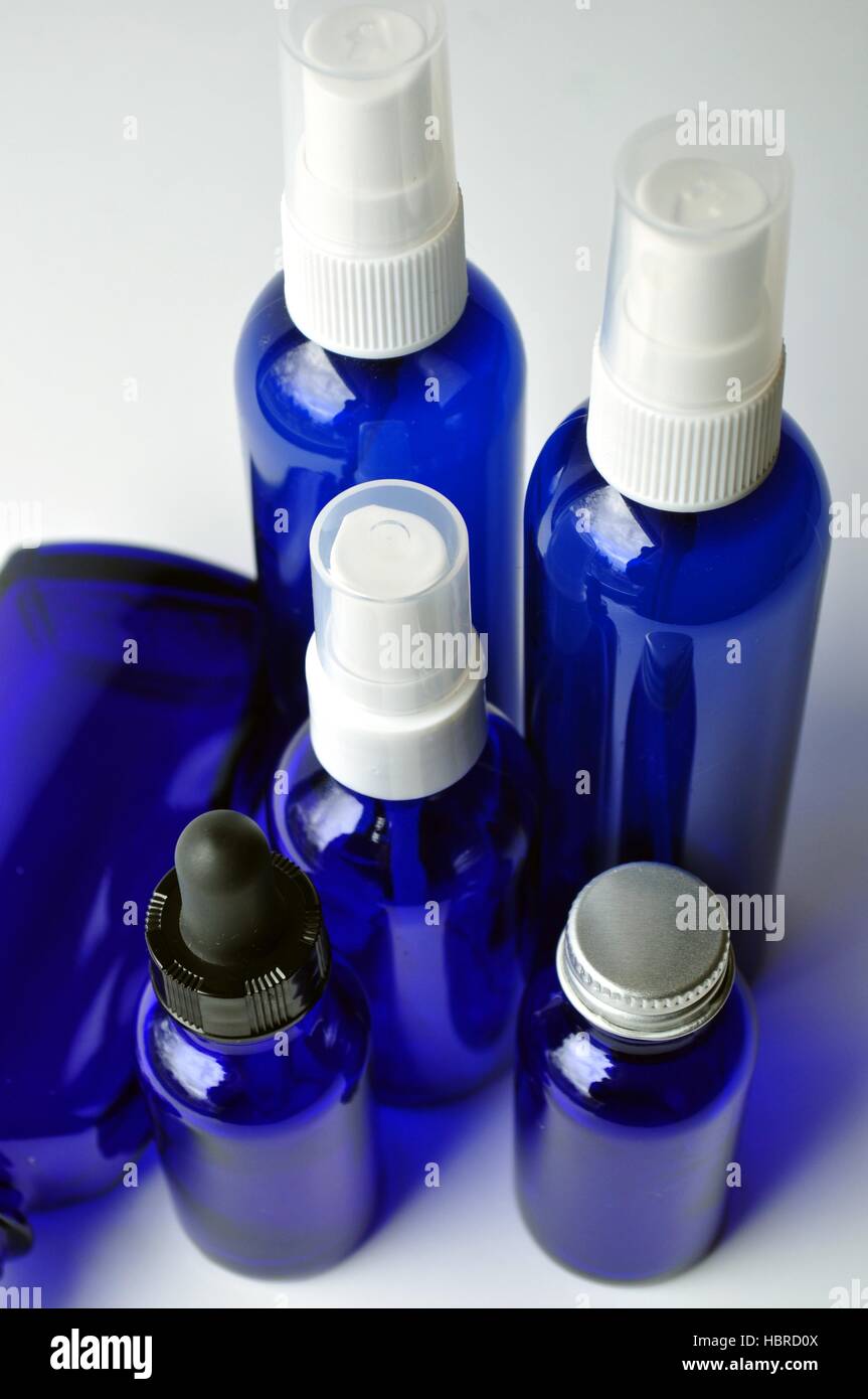 Group of dark blue cosmetic glass bottles for essential oils ...