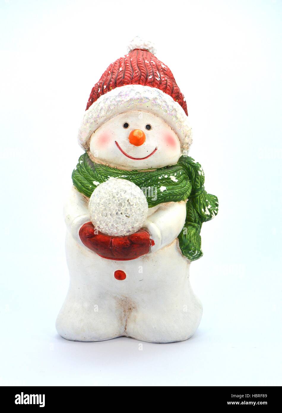 Snowman with a branch and a green scarf Stock Photo - Alamy