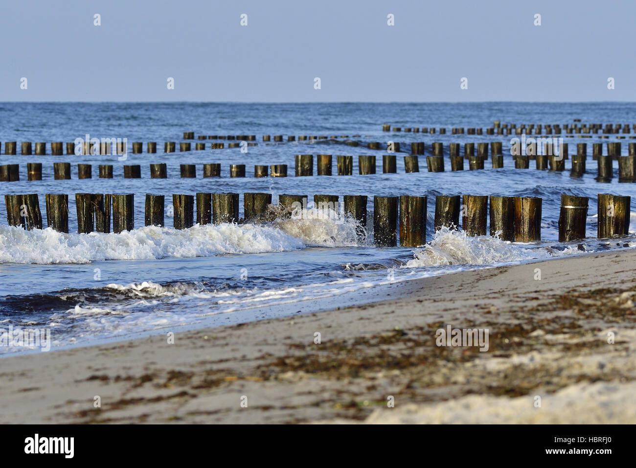 Groins and waves Stock Photo - Alamy