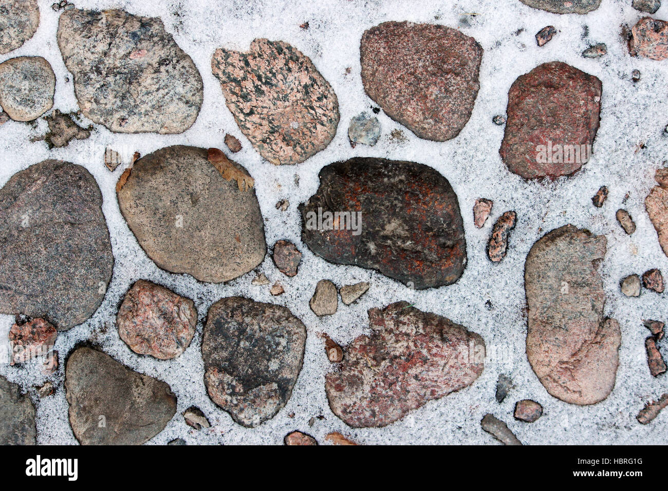 texture of a cobblestone road, strewn with the first snow Stock Photo ...