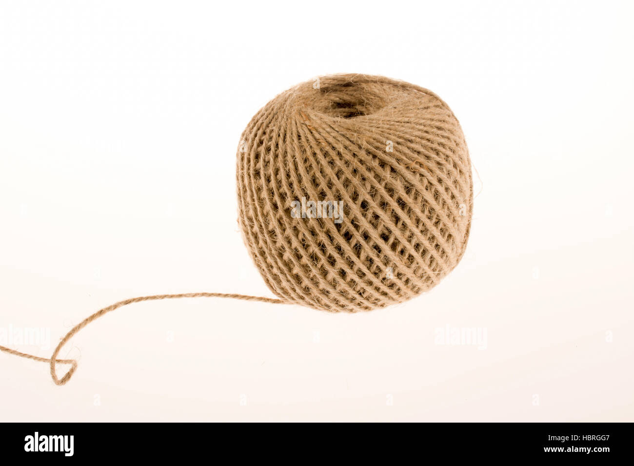 Roll of brown color linen string on a white background Stock Photo - Alamy