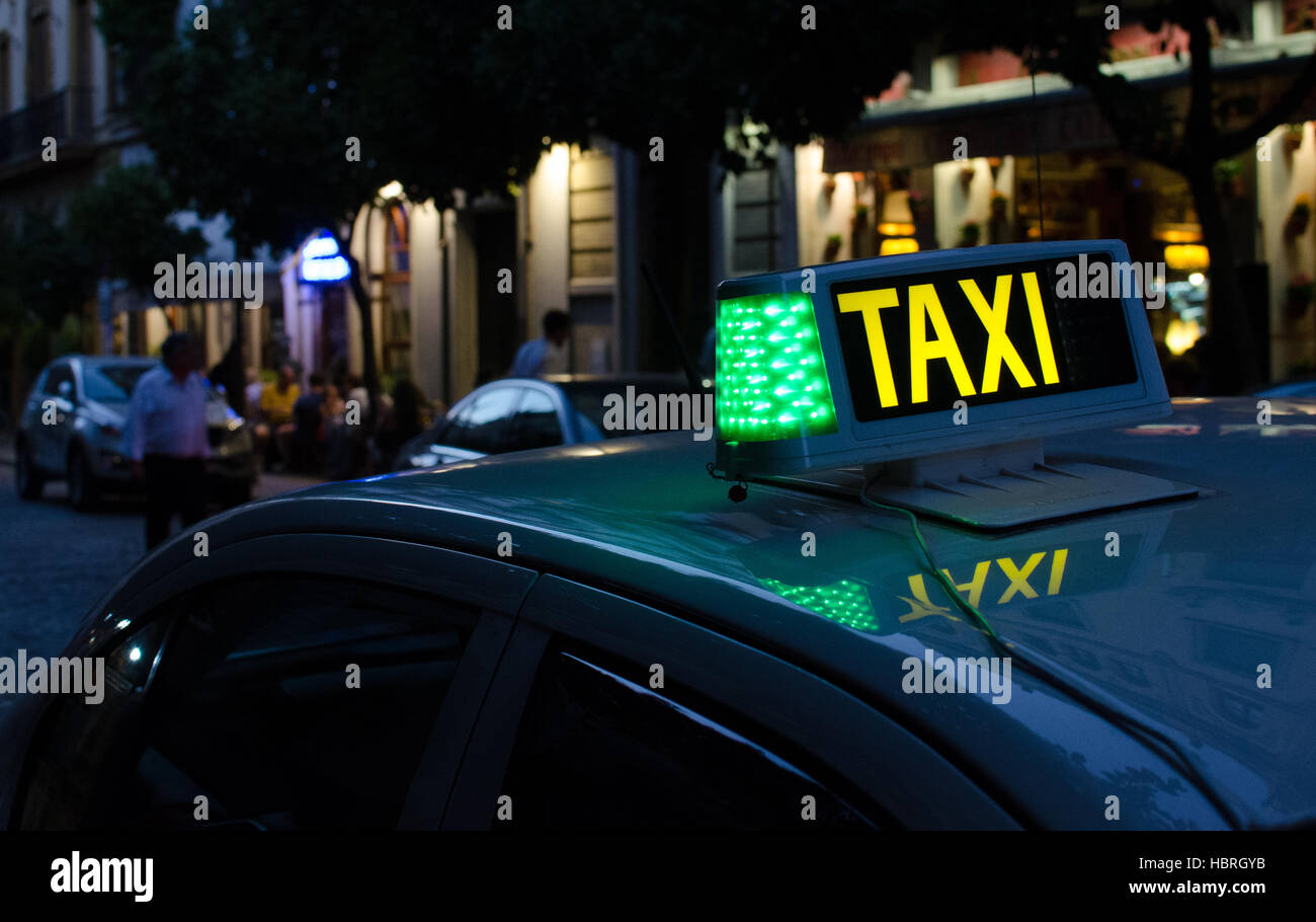 A taxi parked along the road waiting for the next passenger Stock Photo ...
