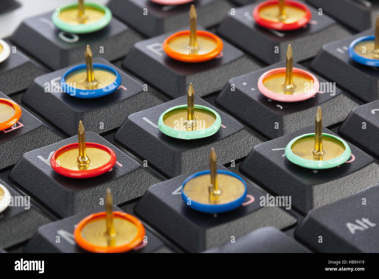 Pins on computer keyboard Stock Photo - Alamy