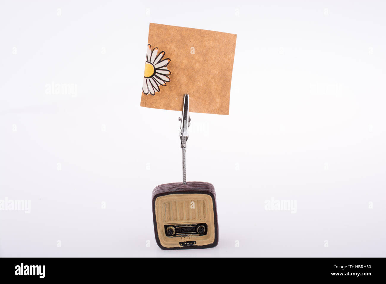 Note paper attached to an retro styled radio on a white background ...