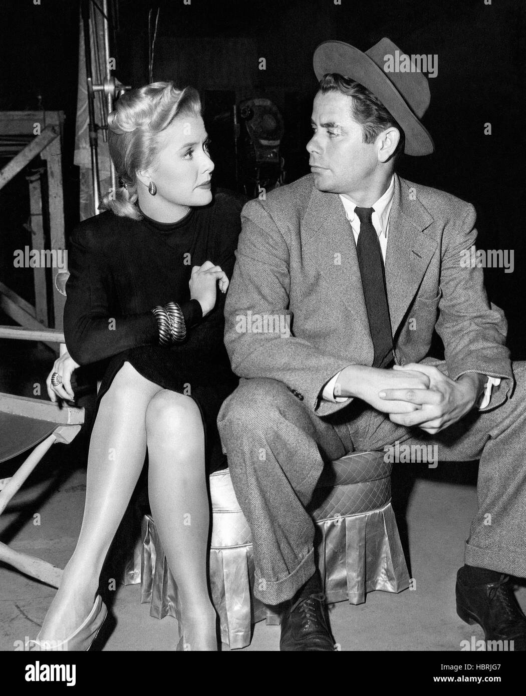 FRAMED, from left, Janis Carter, Glenn Ford, on-set between scenes ...