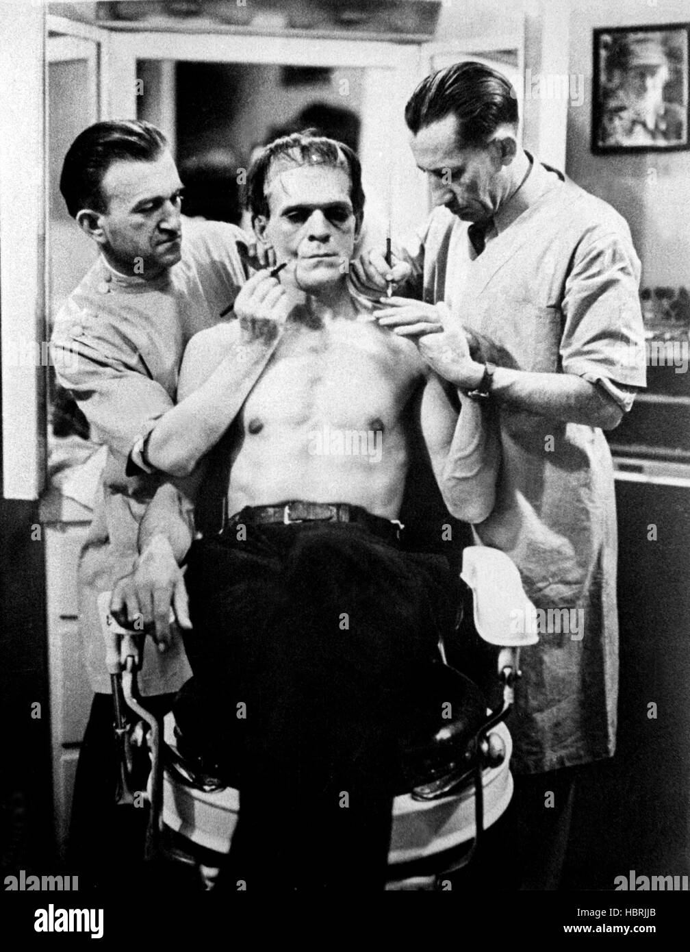 FRANKENSTEIN, Jack Pierce and assistant putting makeup on Boris Karloff ...