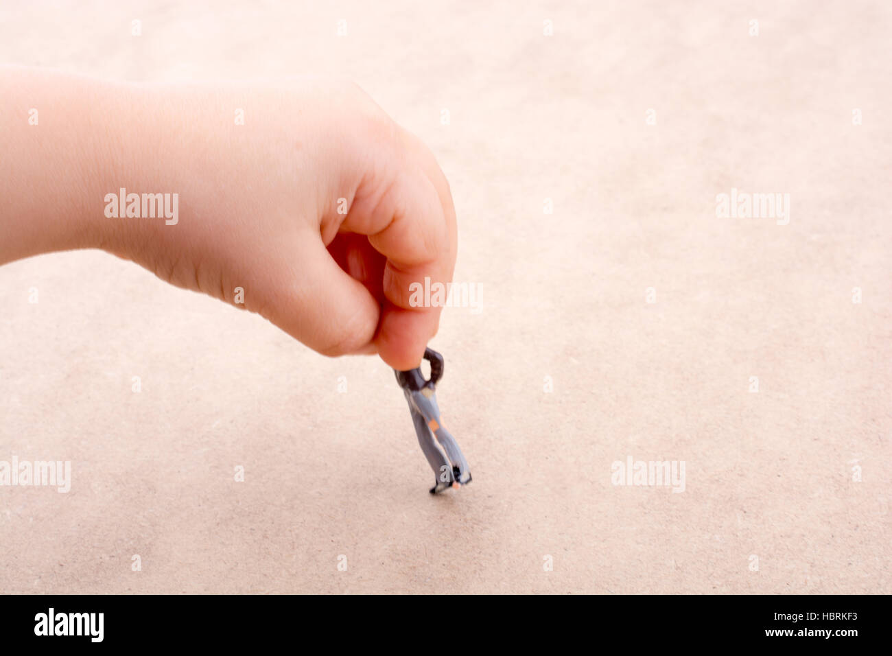Little man figure in hand on a white background Stock Photo - Alamy