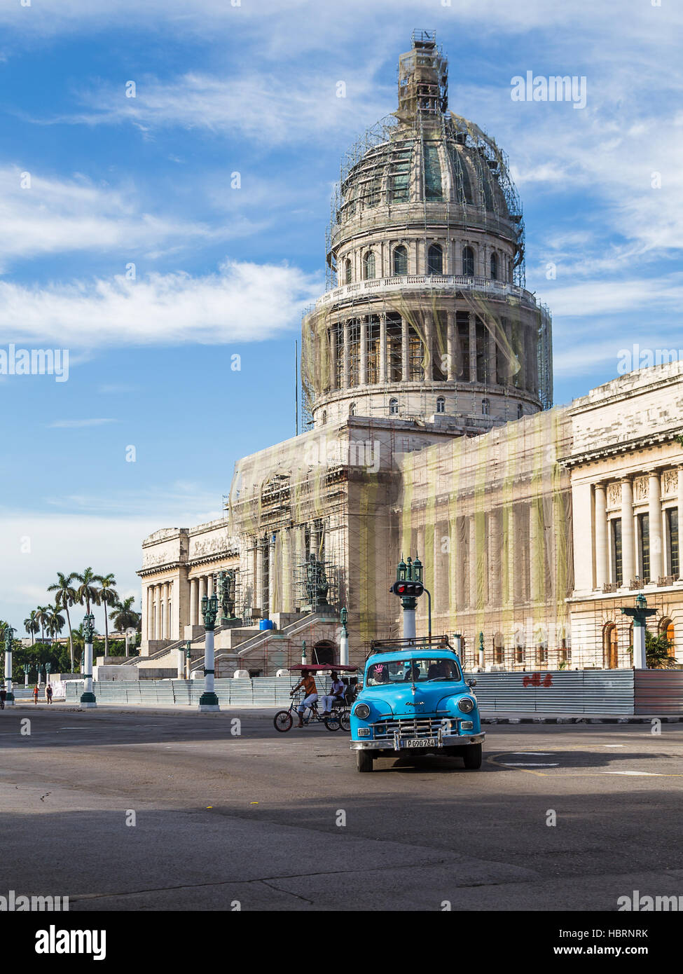 A colourful old timer passes in front of the iconic National Capitol ...