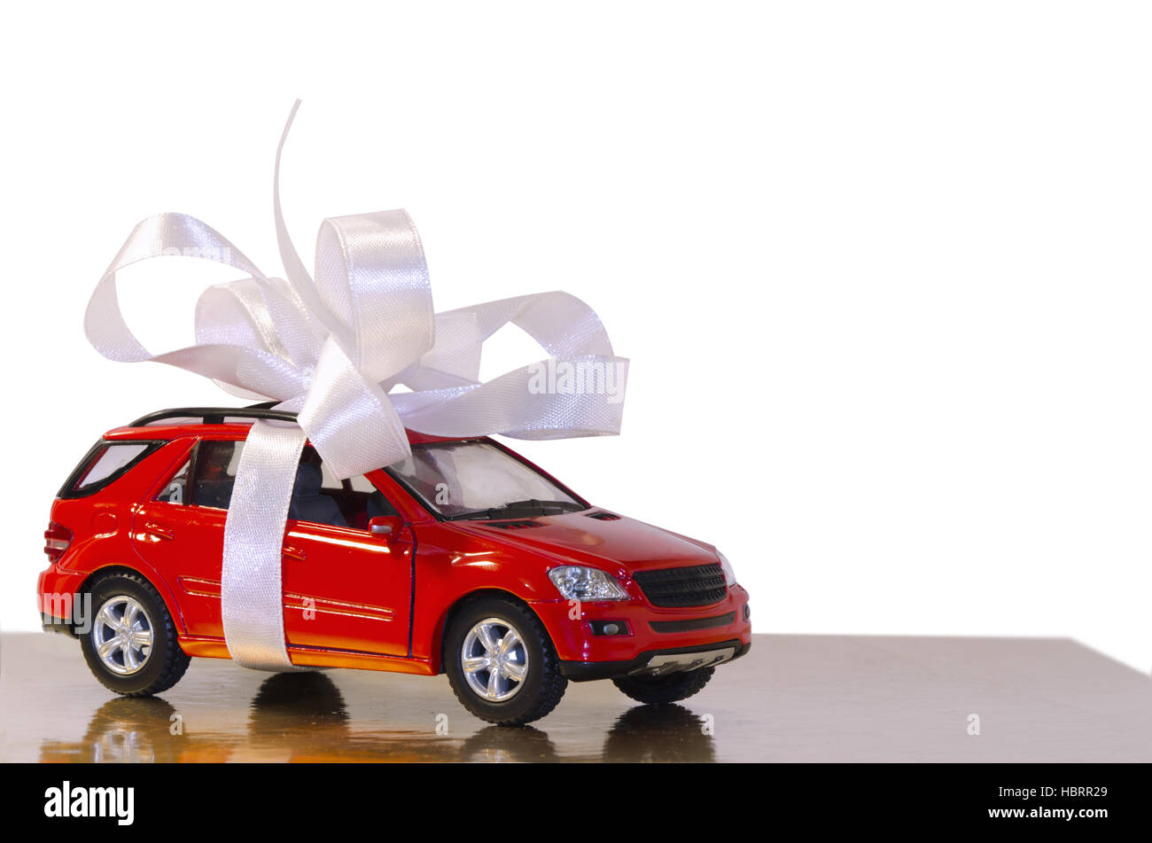 Red car, tied with white ribbon Stock Photo - Alamy