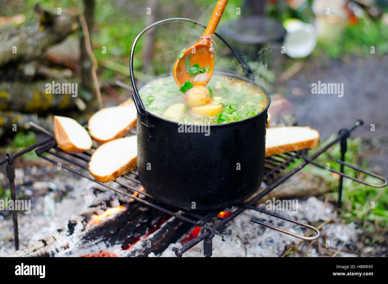 The cooking of soup on the fire Stock Photo - Alamy