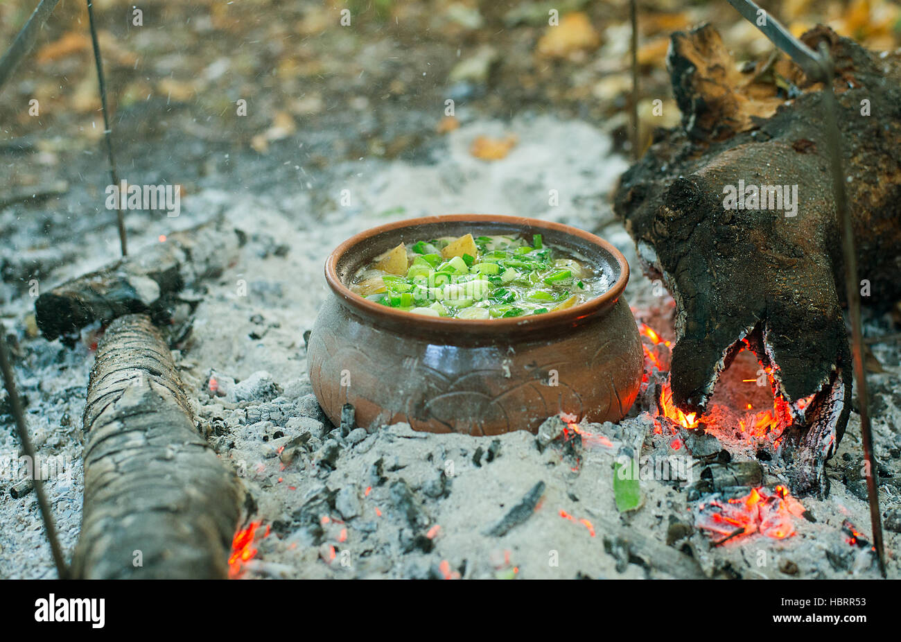 Roast in a clay pot on the fire Stock Photo - Alamy