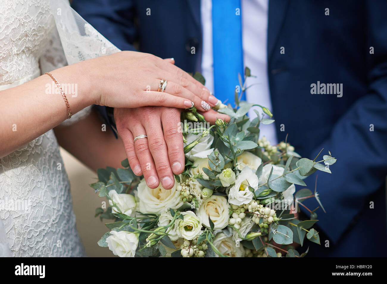 hands of the bride and groom at a wedding bouquet Stock Photo - Alamy
