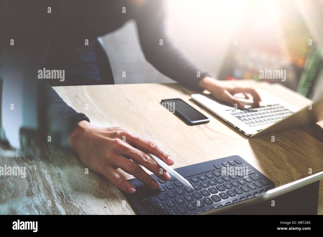 Website designer working digital tablet dock keyboard and computer ...