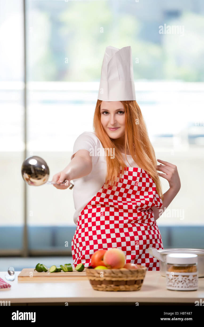 Redhead cook working in the kitchen Stock Photo - Alamy