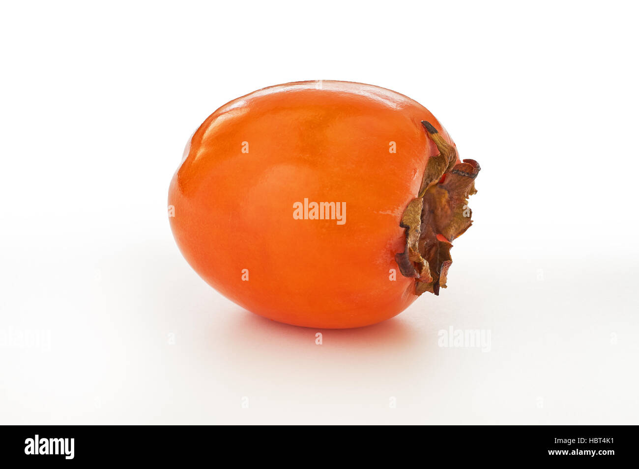Single Japanese persimmon (Diospyros kaki) isolated on white background ...