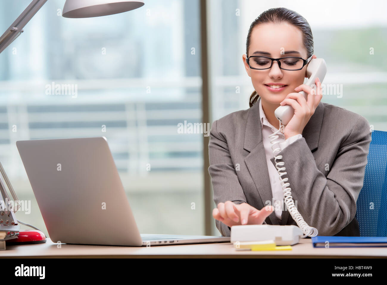 Call center operator working at her desk Stock Photo - Alamy