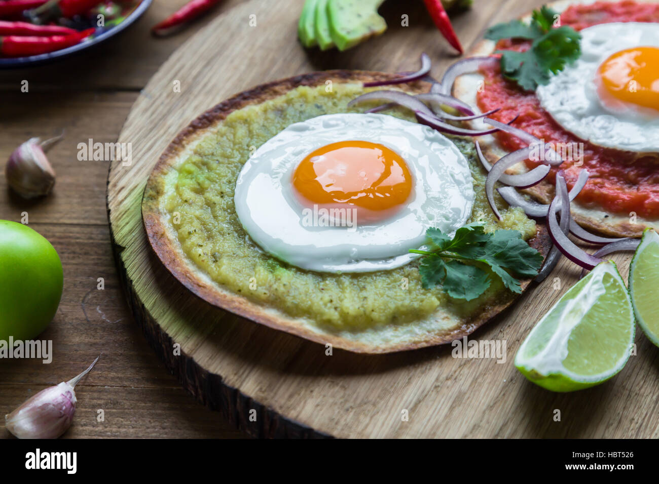Variety of colorful mexican cuisine breakfast dishes on a wooden table ...