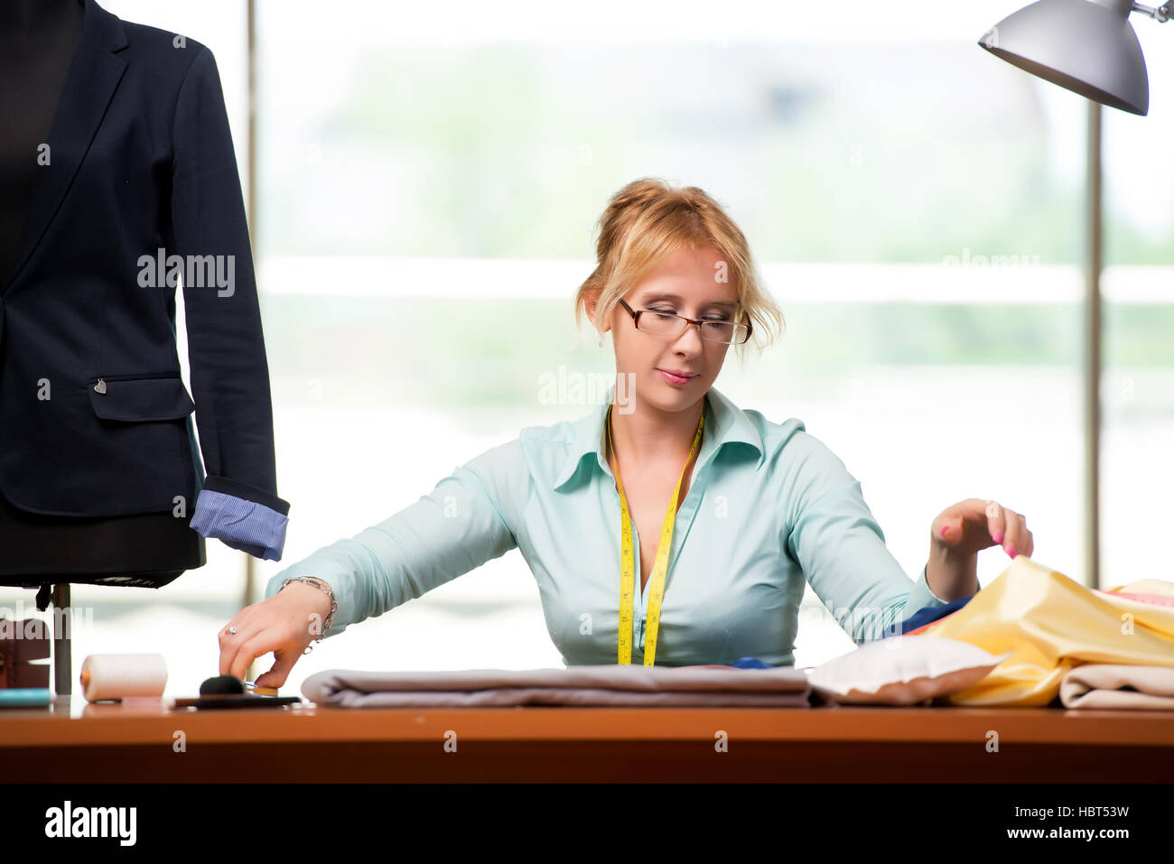 Woman tailor working on new clothing Stock Photo - Alamy