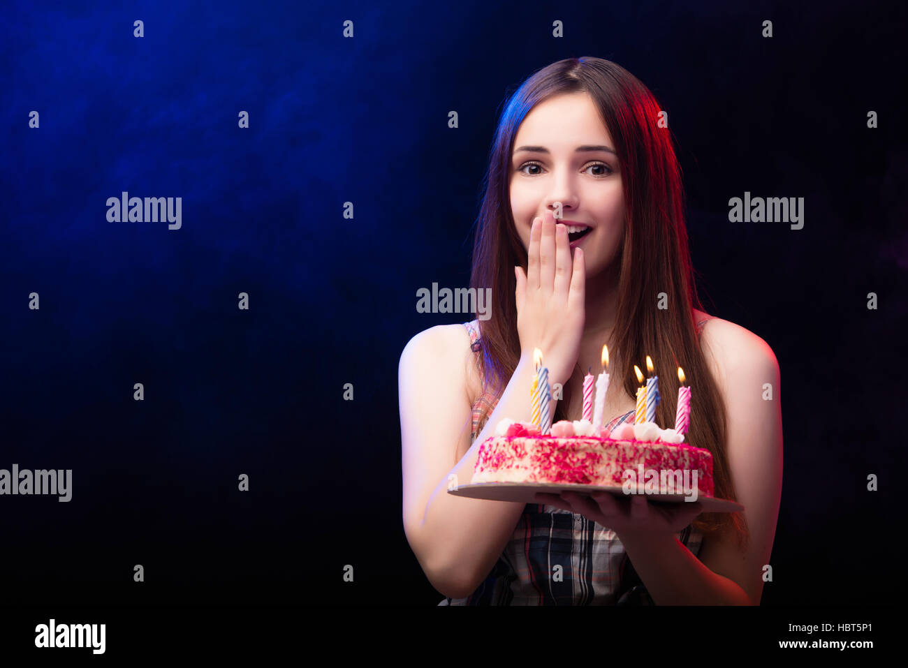Young woman with birthday cake at party Stock Photo - Alamy