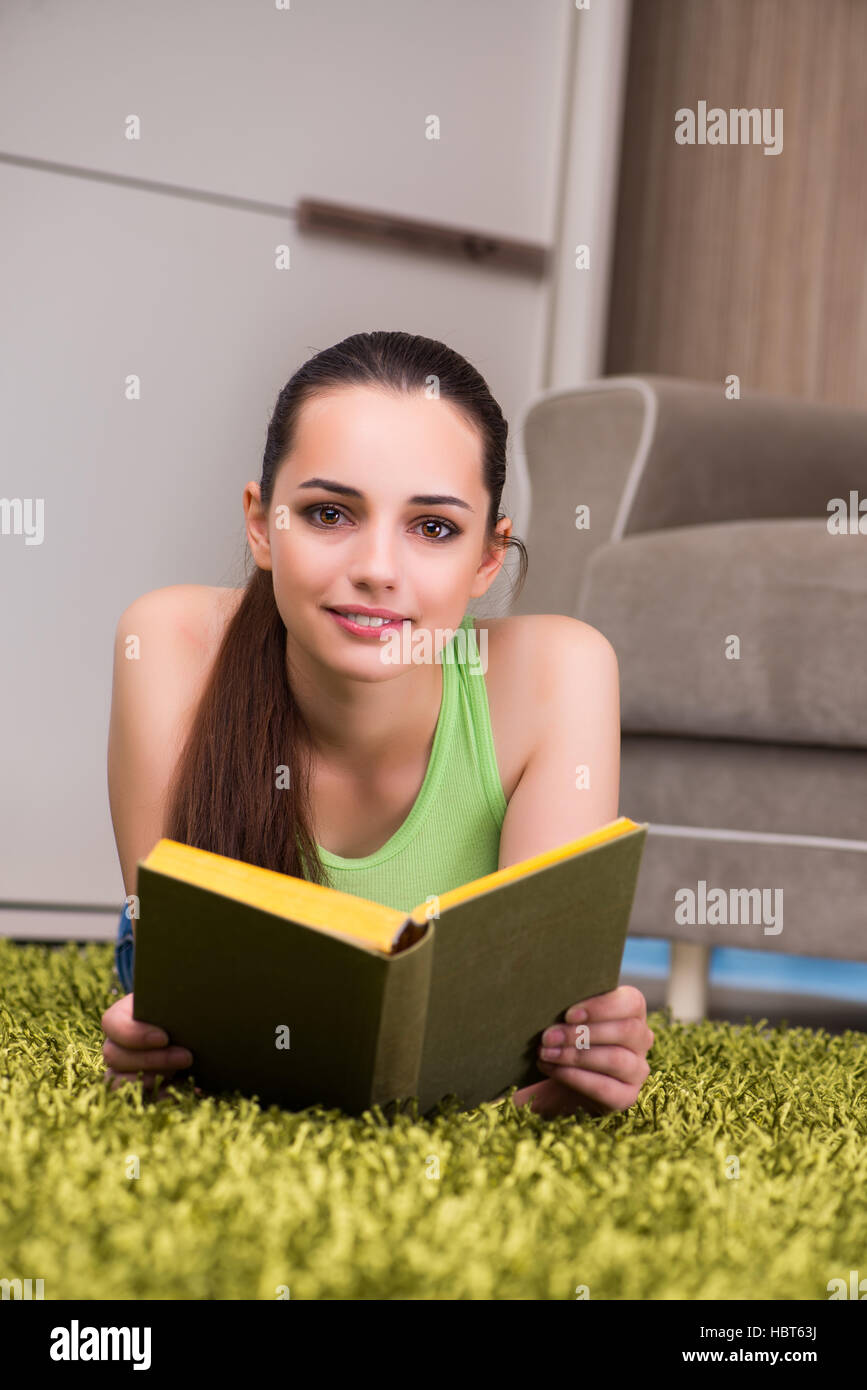 Young woman reading books at home Stock Photo - Alamy