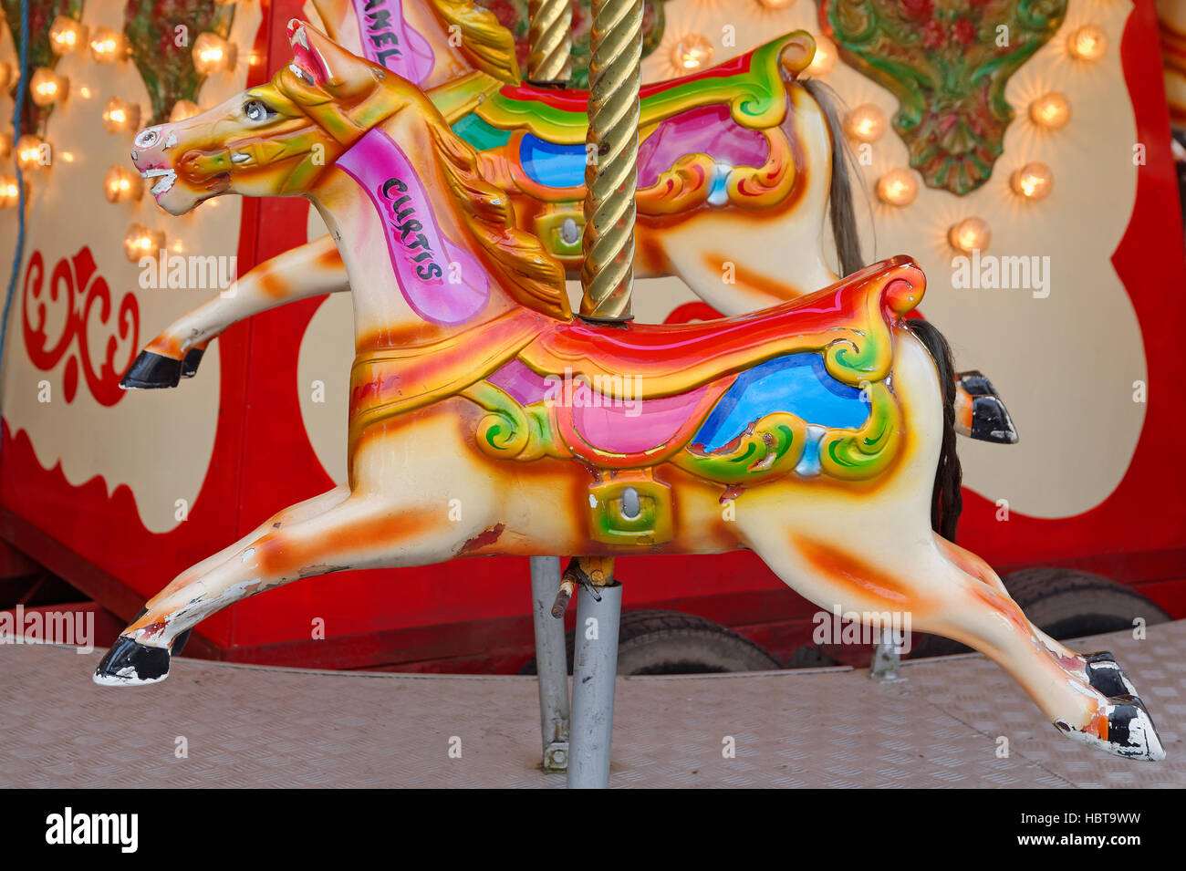 Close up of an antique, wooden carnival horse on a fairground carousel ...