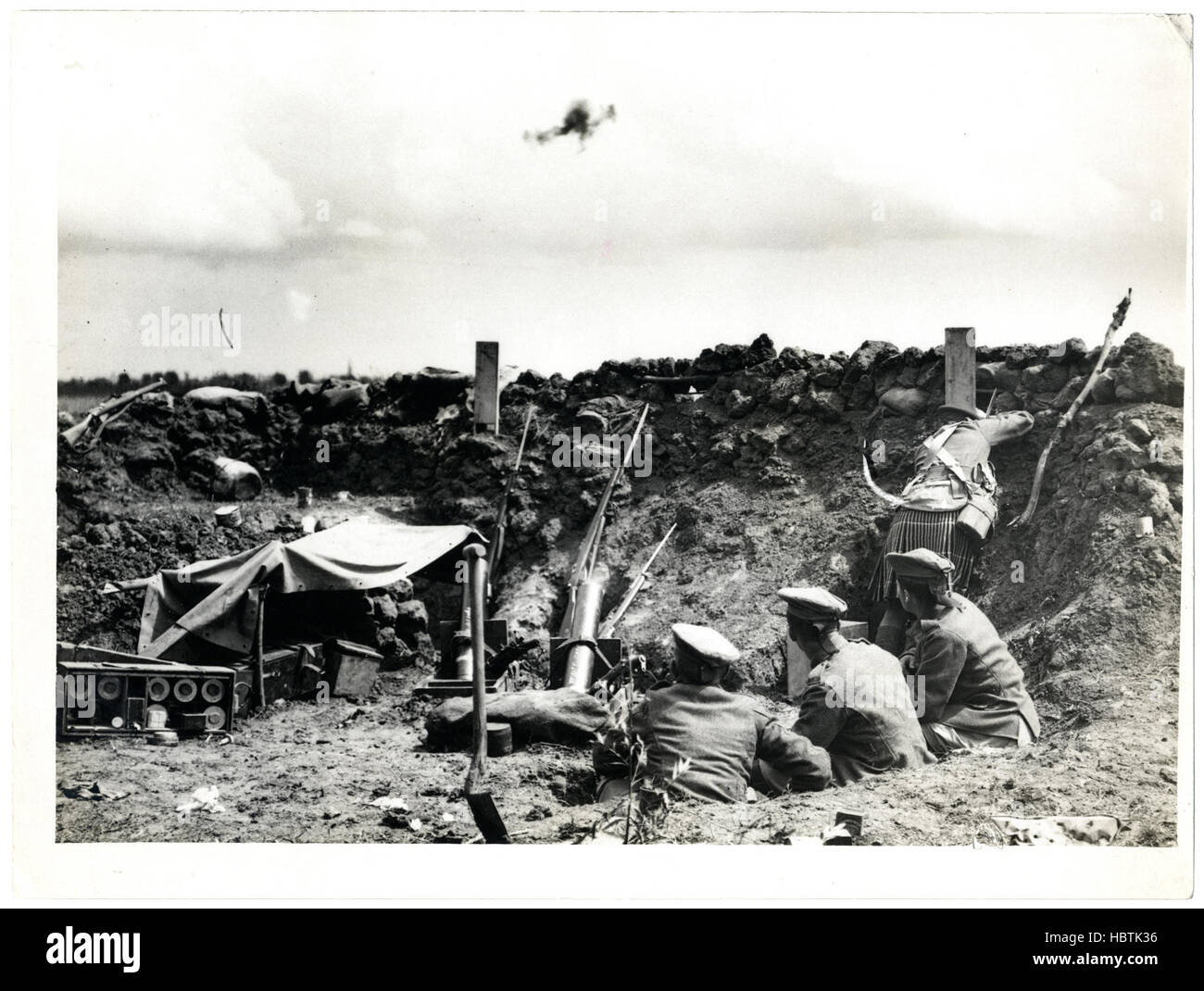 The image depicts a Bomb Gun Section firing a bomb during a military ...