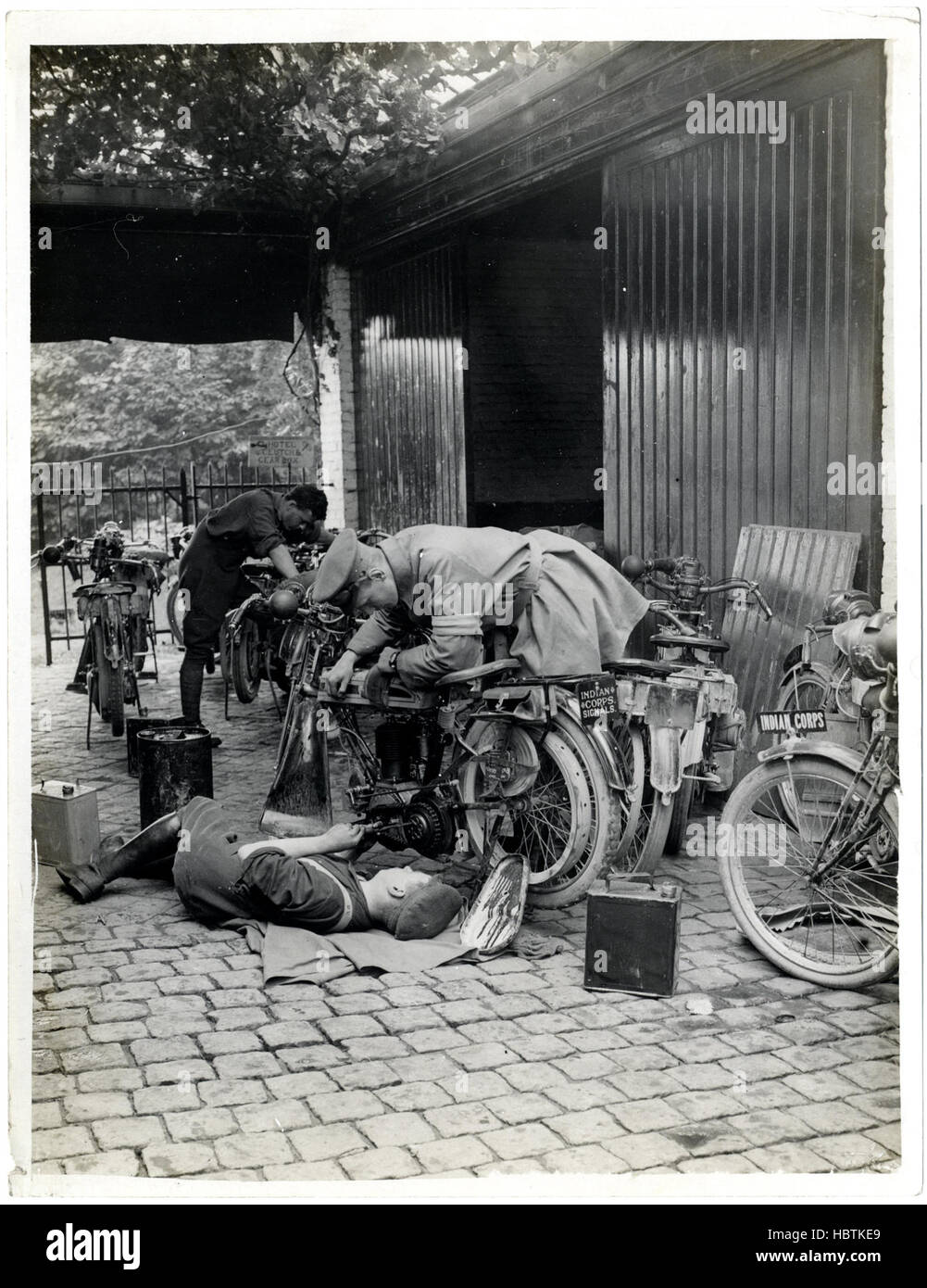 This image shows an Indian Corps dispatch rider performing maintenance ...