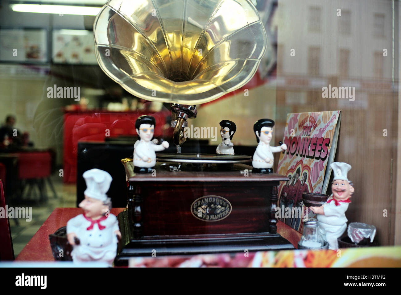 Old fashioned gramophone with small models of Elvis Presley in London ...