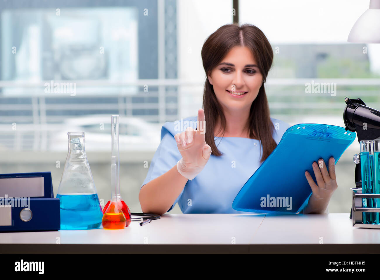 Young woman pressing buttons in lab Stock Photo - Alamy