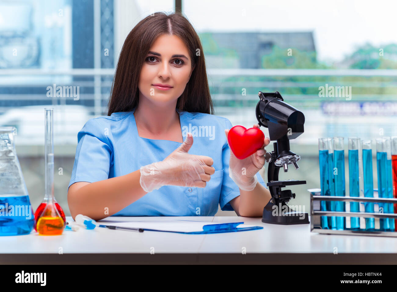 Young doctor with red heart in lab Stock Photo - Alamy
