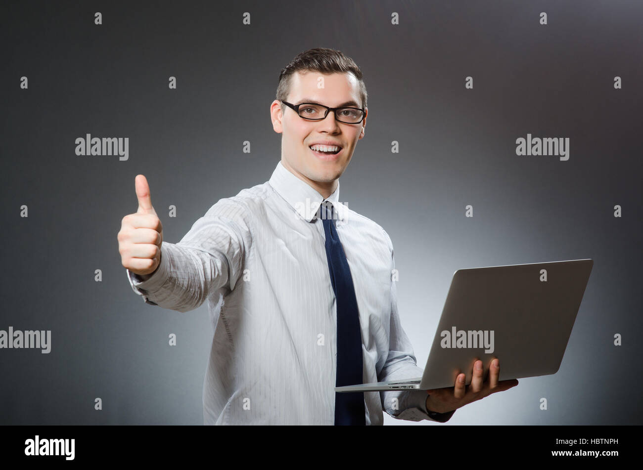 Man with laptop and thumbs up Stock Photo - Alamy