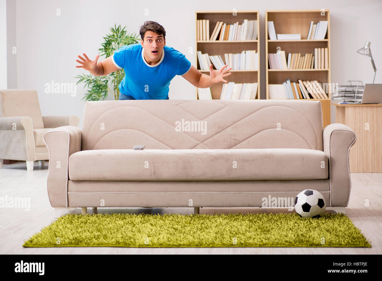 Man watching football at home Stock Photo - Alamy