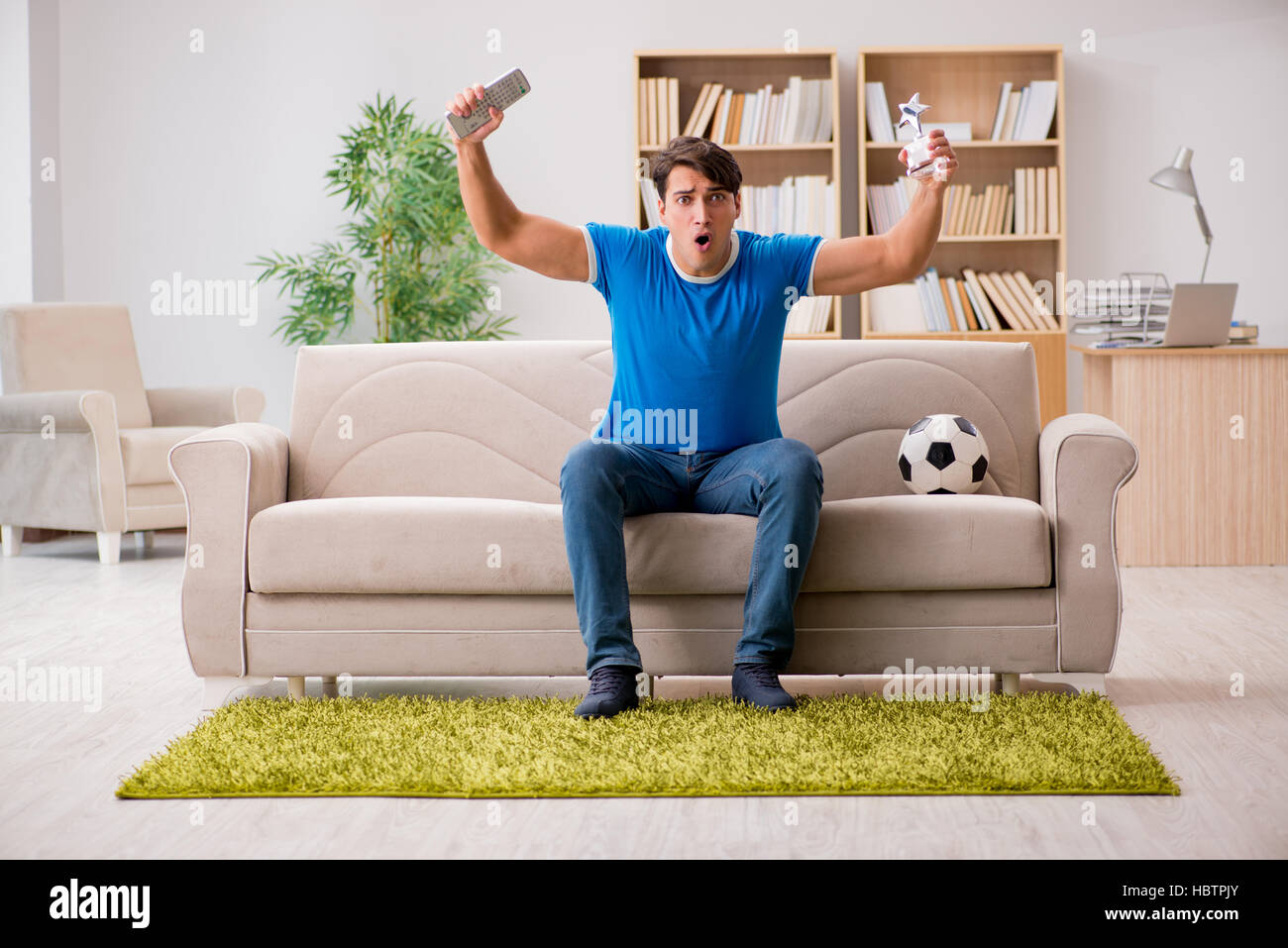 Man watching football at home Stock Photo - Alamy