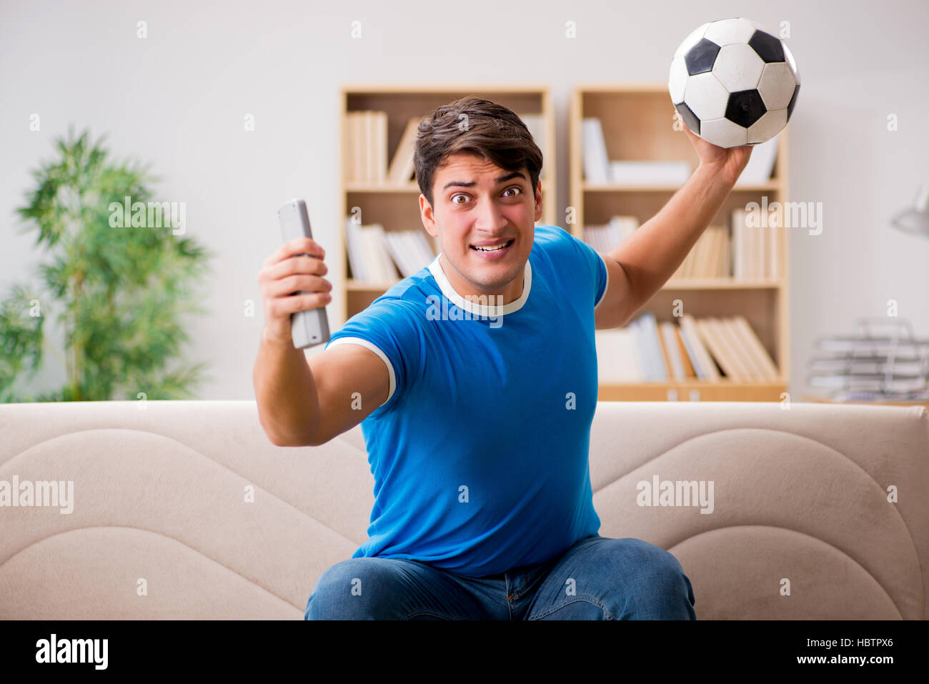 Man watching football at home Stock Photo - Alamy