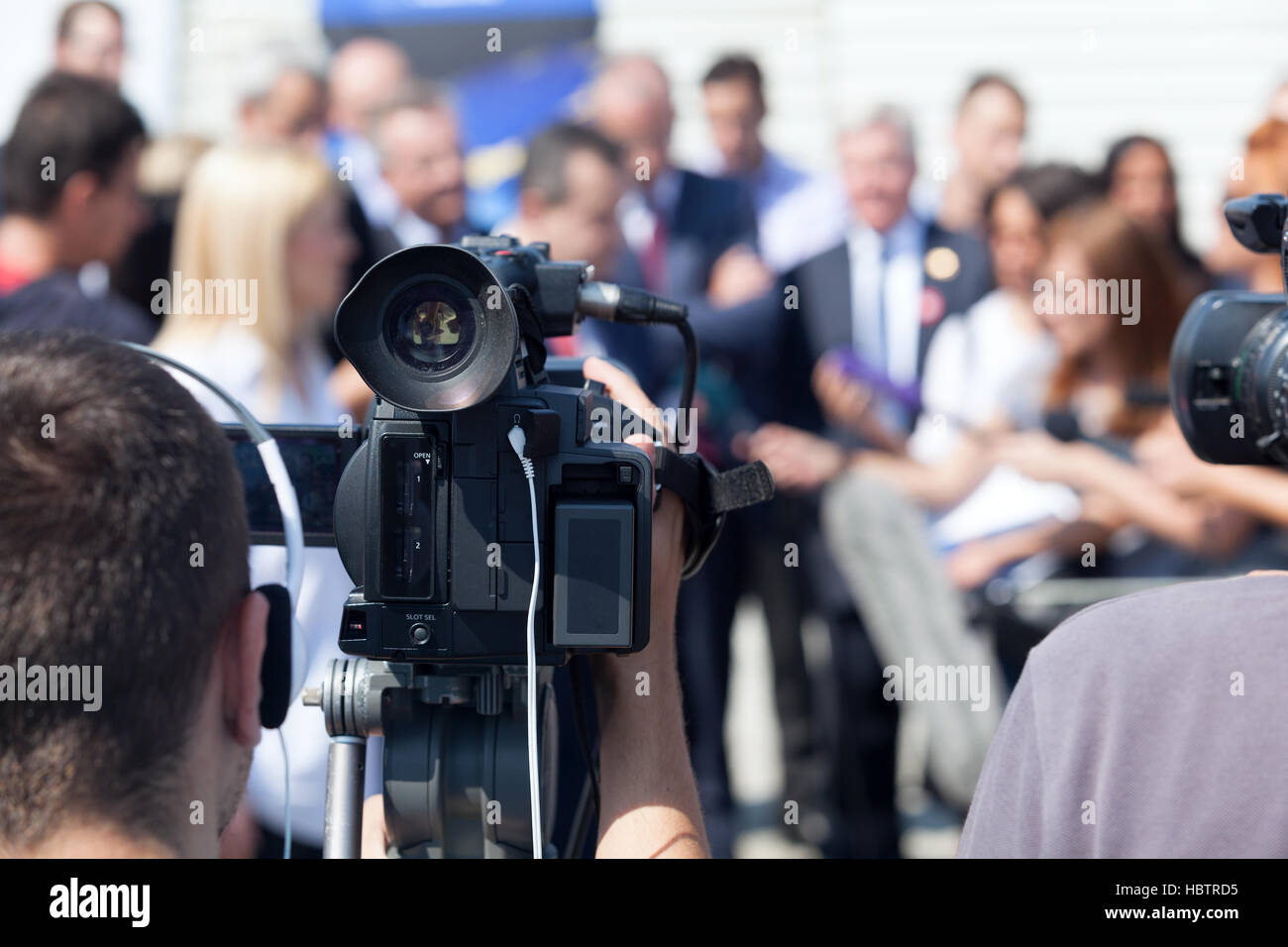 Filming an media event with a video camera. Press conference Stock ...