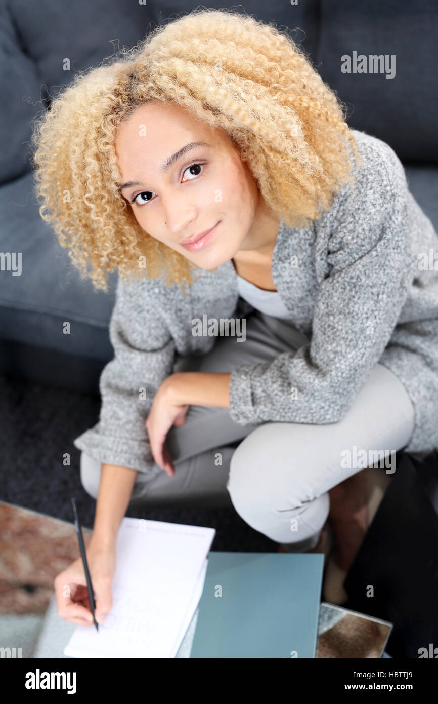 The woman writes in a notebook. Shopping. Girl taking notes while ...