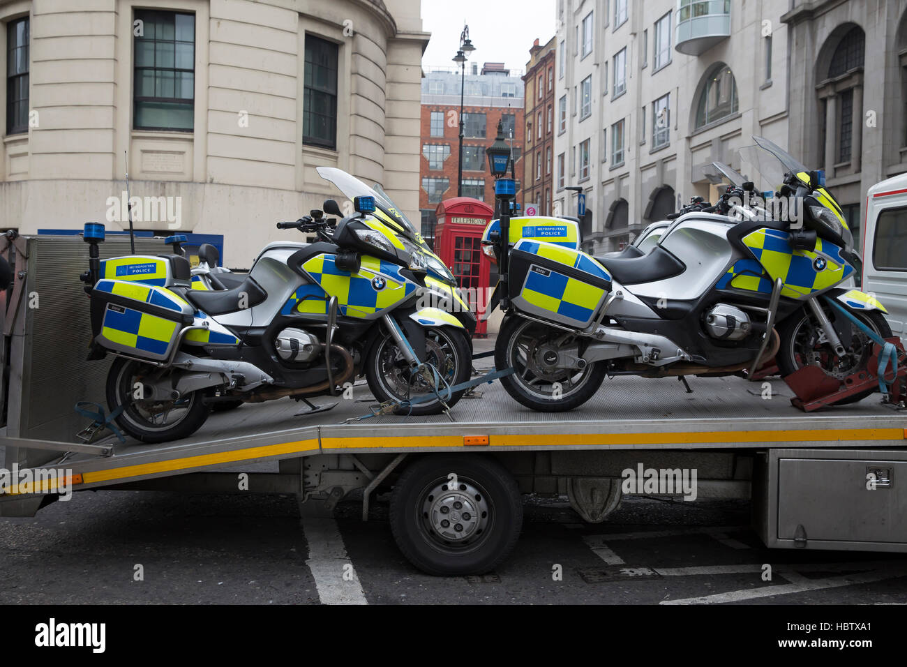 Four police motorbikes on the back of a car transporter in central ...