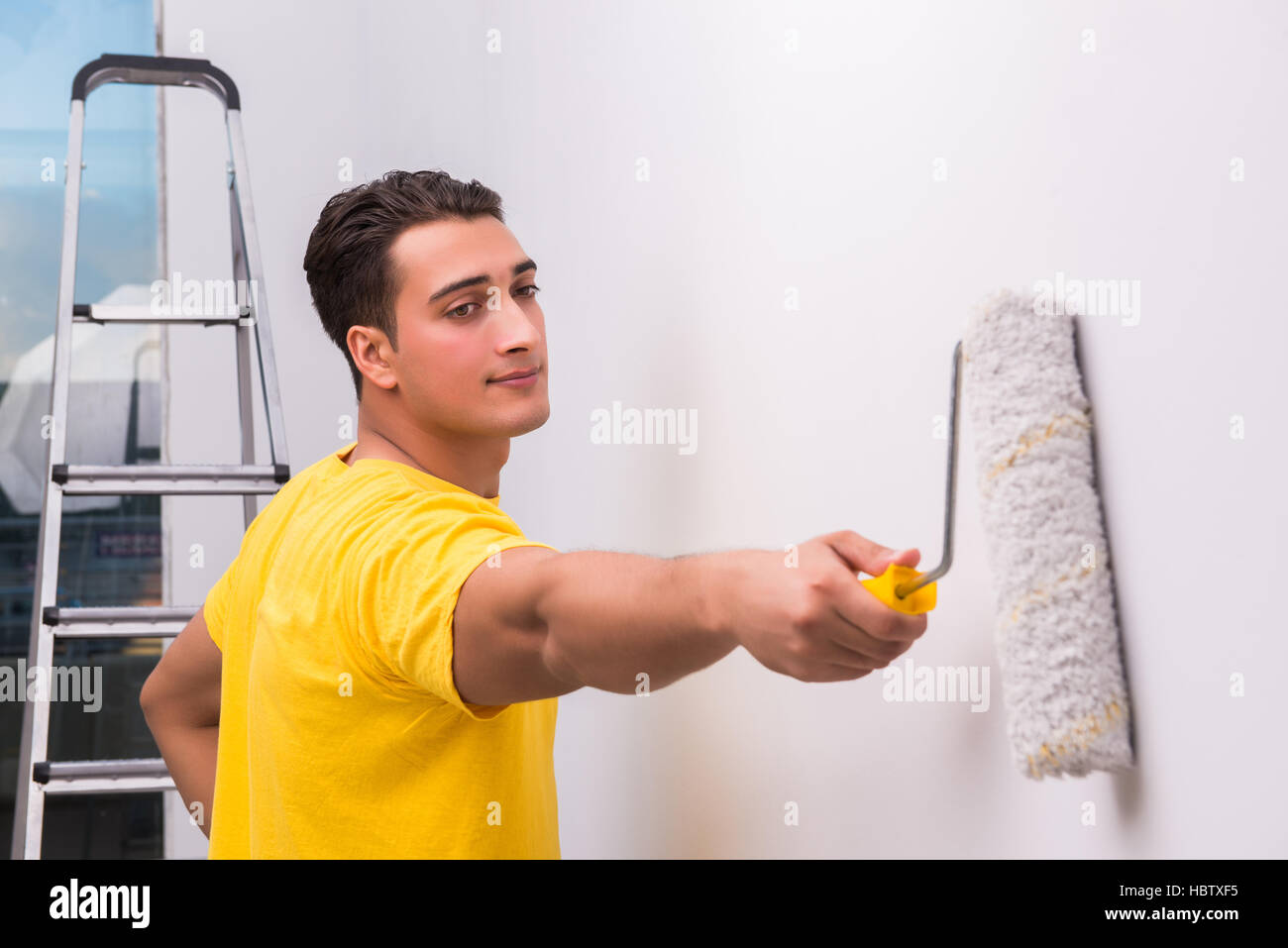 Man painting house in DIY concept Stock Photo - Alamy