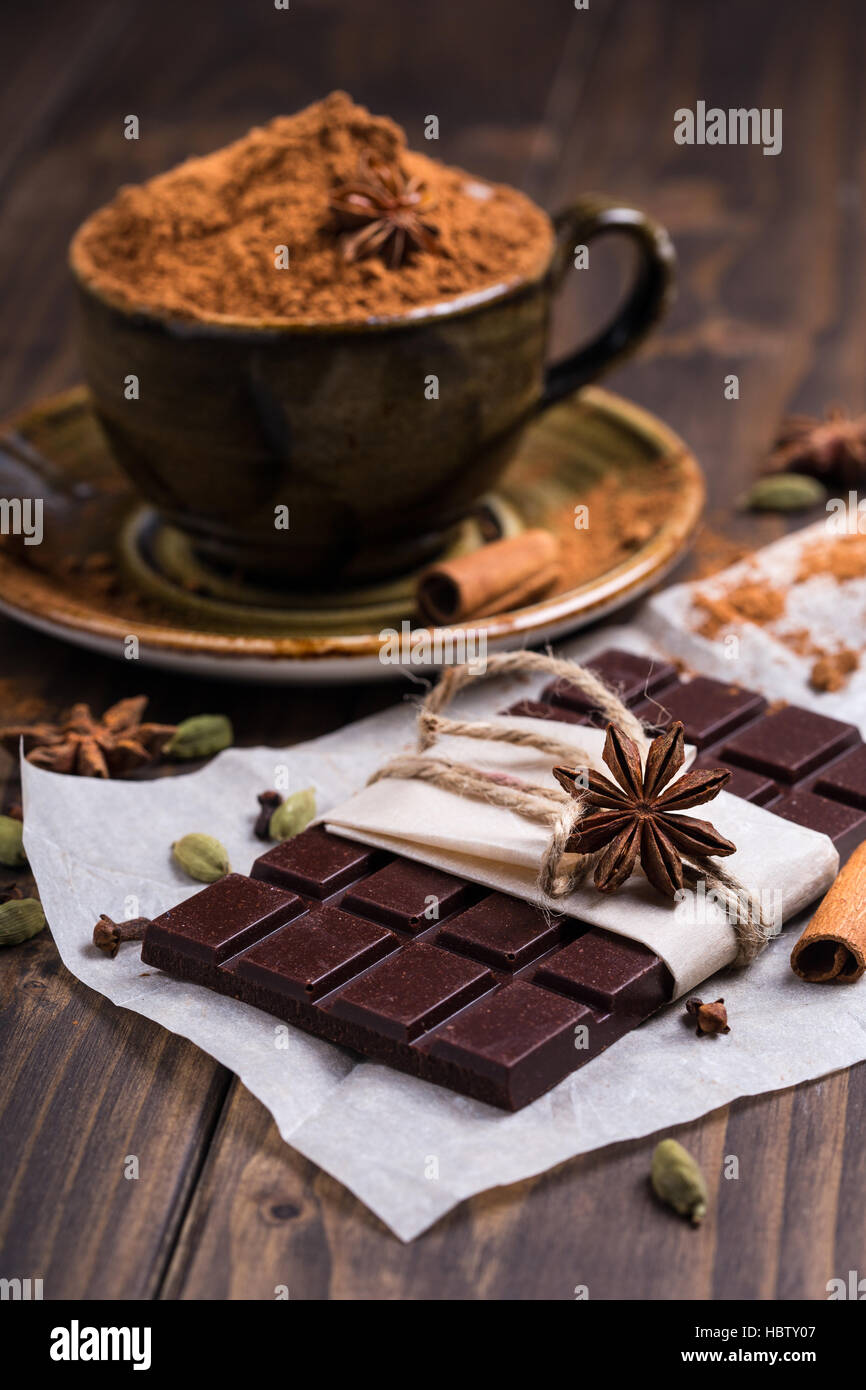 Bitter chocolate bar with raw cacao on background Stock Photo - Alamy