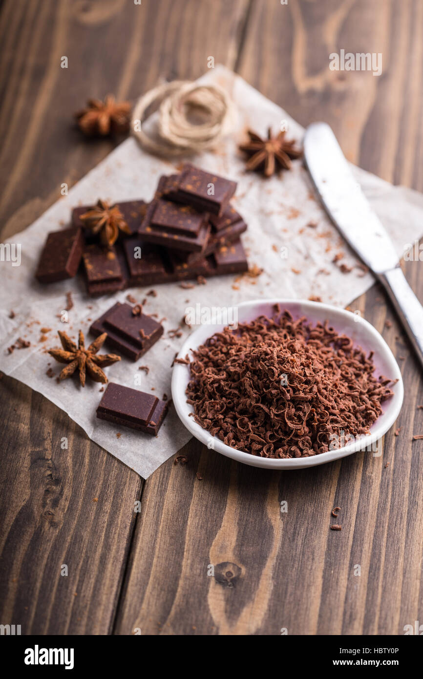 Grated dark chocolate with some pieces of chocolate on background Stock ...