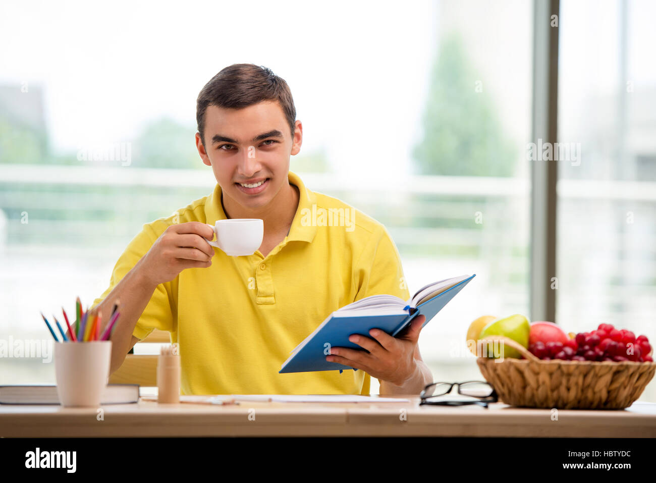 The student reading book and drinking tea Stock Photo - Alamy
