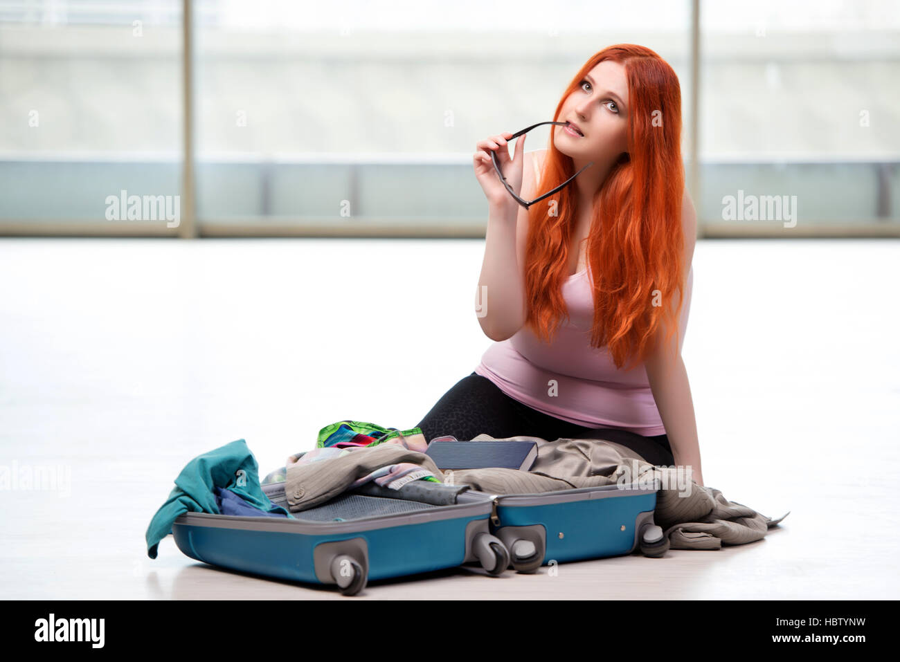 The young woman packing for travel vacation Stock Photo - Alamy