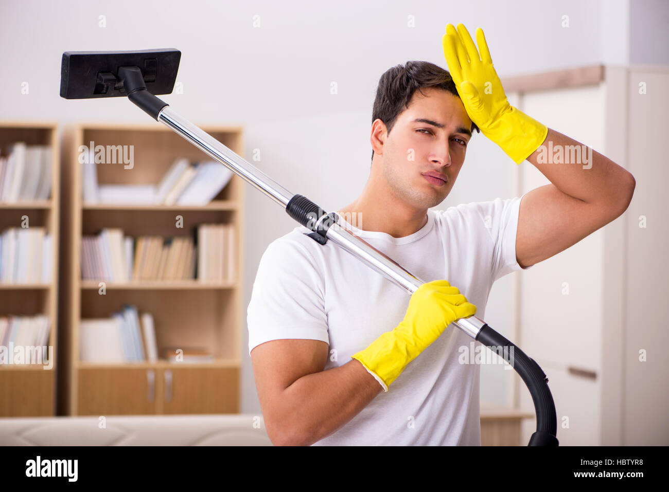 Man cleaning home with vacuum cleaner Stock Photo - Alamy