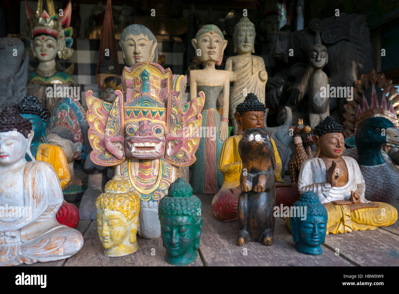 Colored Balinese wooden statues in tourist market in Ubud. Indonesia ...