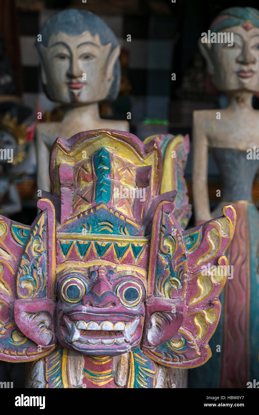 Colored Balinese wooden statues in tourist market in Ubud. Indonesia ...