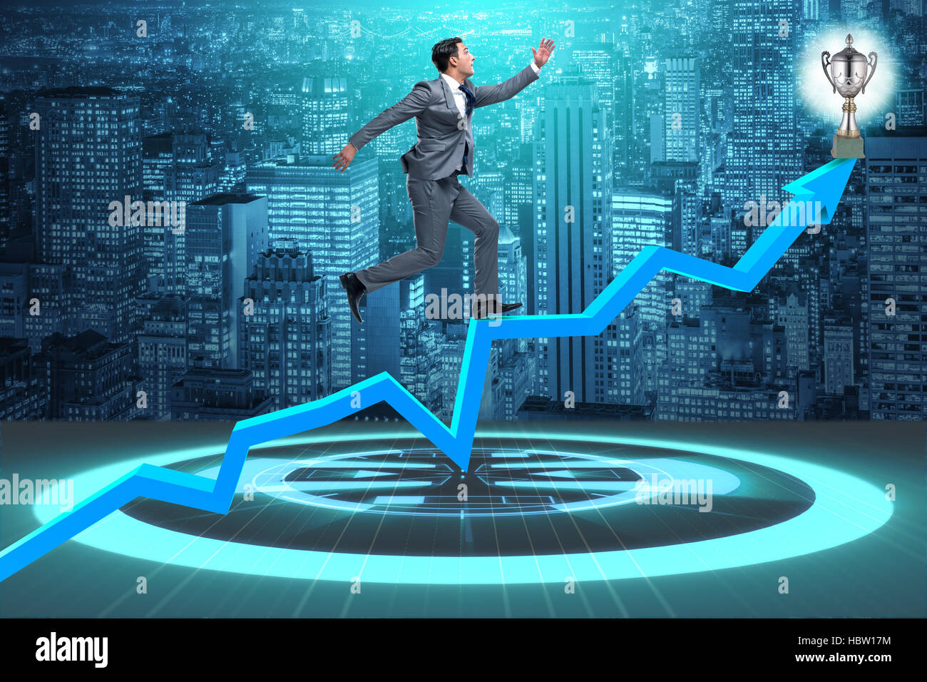 Businessman running towards prize cup trophy Stock Photo - Alamy