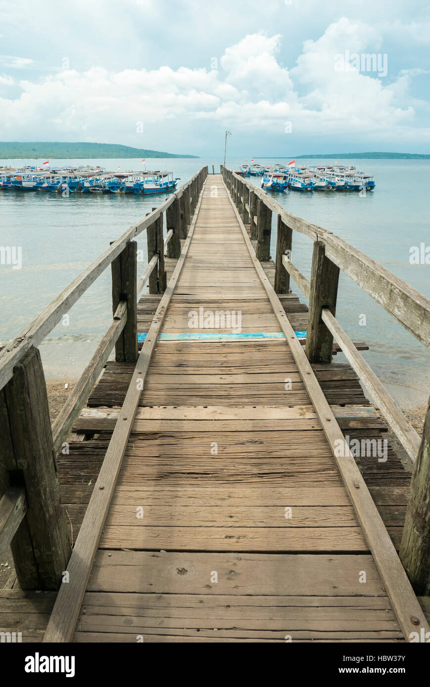 Wooden pier with Balinese boats near Taman Barrat National Park ...