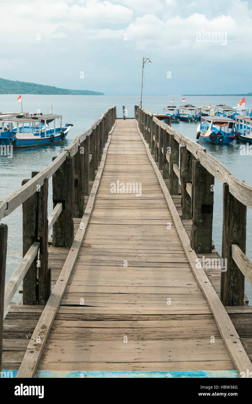 Wooden pier with Balinese boats near Taman Barrat National Park ...
