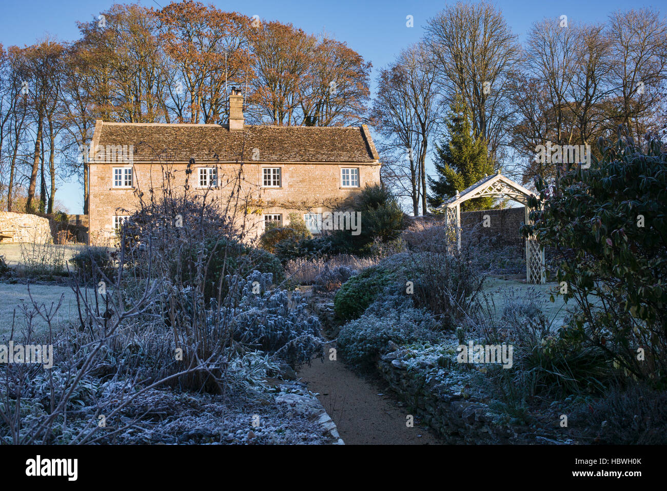 Cottage and early morning frost with sunlight in Ablington, Cotswolds ...