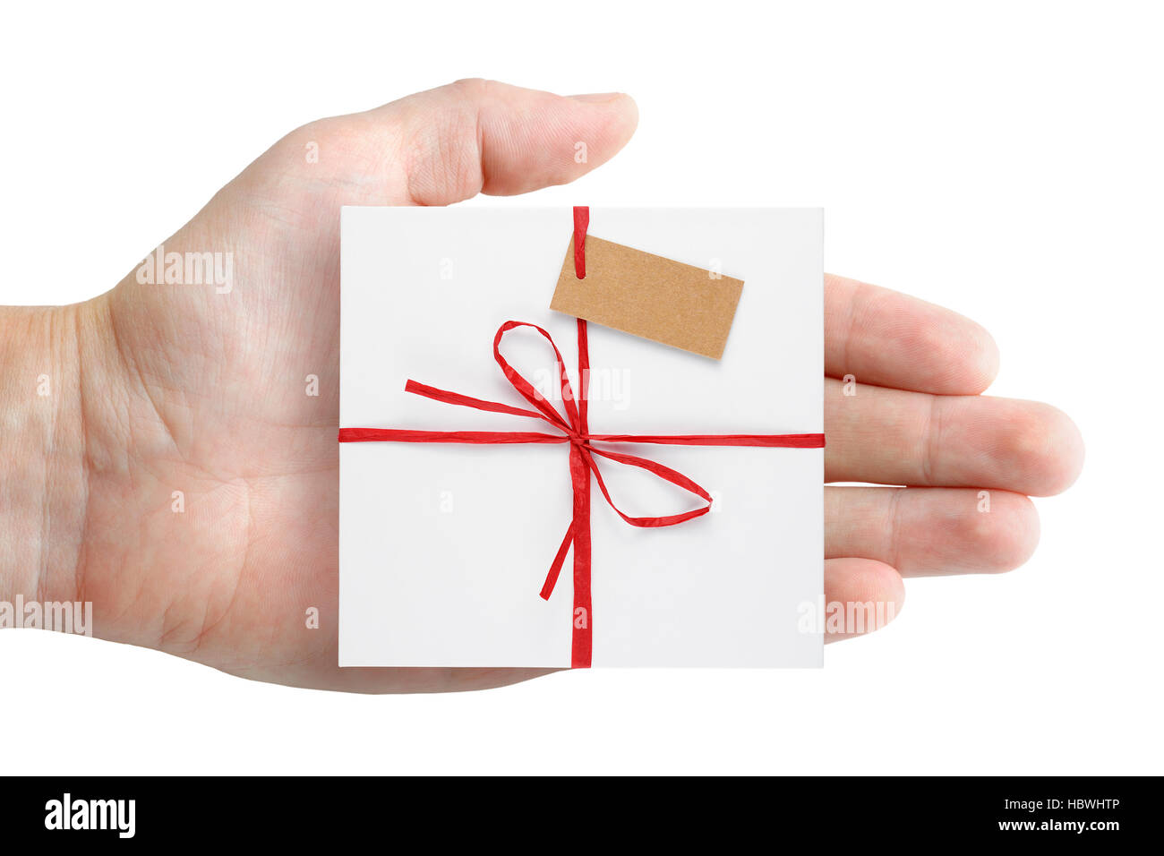 Gift box with tag in hand isolated on white background Stock Photo - Alamy